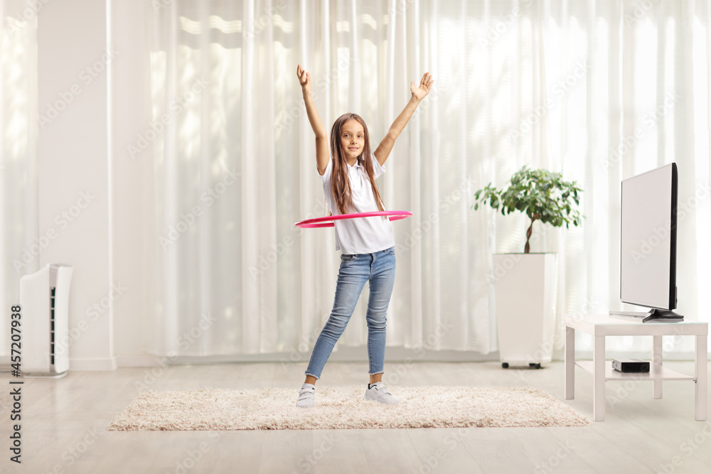 Child spinning a hula hoop at home Stock Photo | Adobe Stock