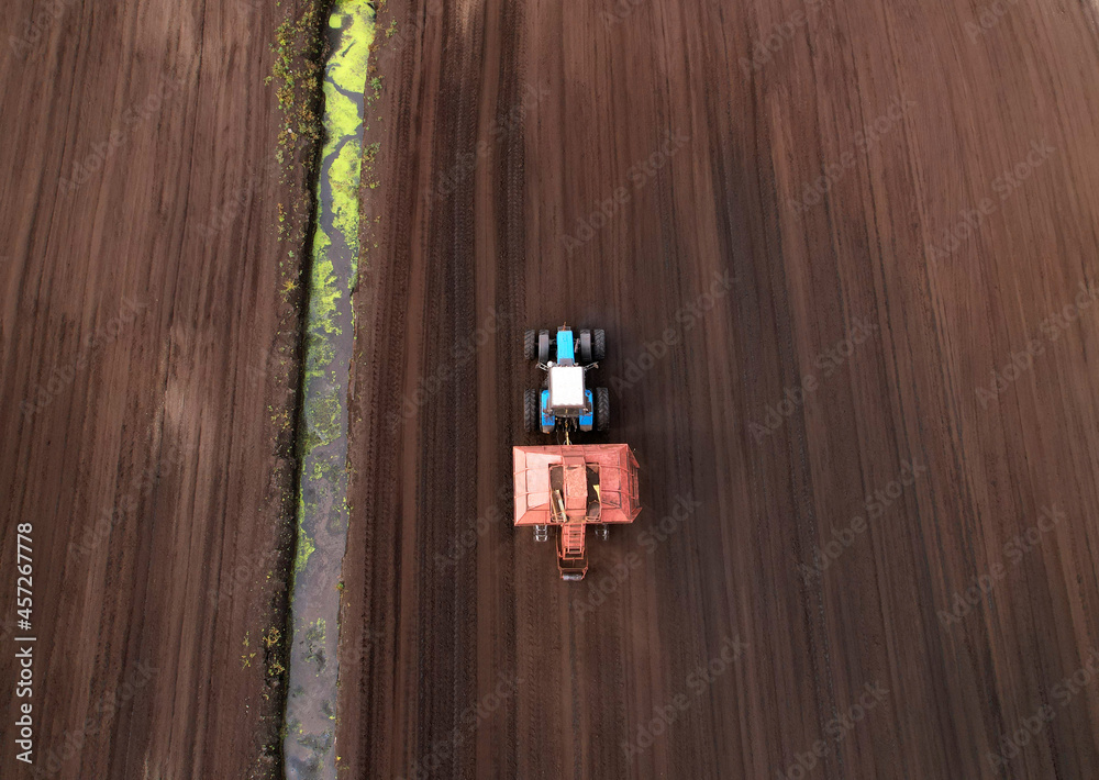 Peat Harvester Tractor on Collecting Extracting Peat. Mining and ...