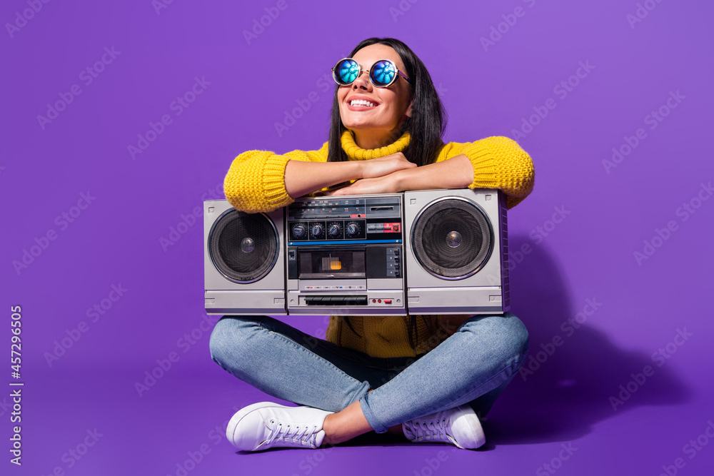 Full length portrait of charming cheerful girl put arms on boombox ...