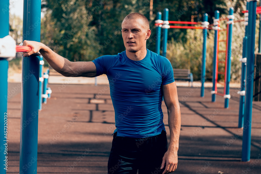 Man posing at playground, training muscles outdoors, healthy lifestyle ...