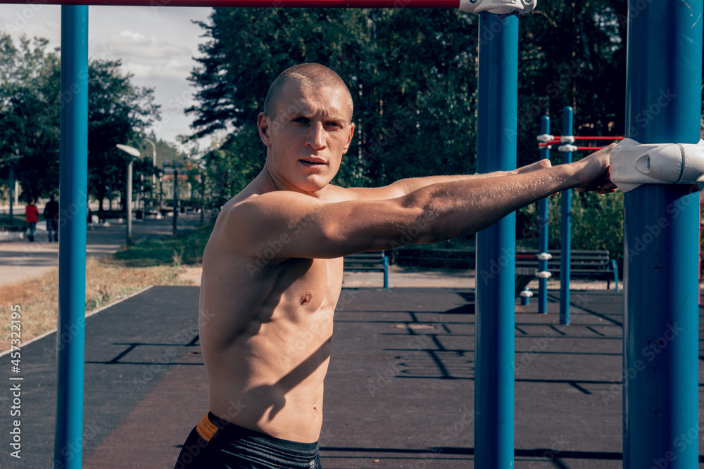 strong trained man athlete posing on the sports field, muscular strong ...