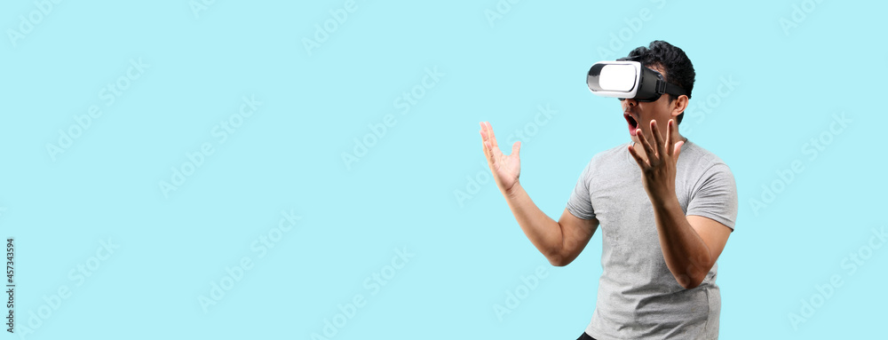 Asian man playing VR video game with virtual reality goggles and Shock ...