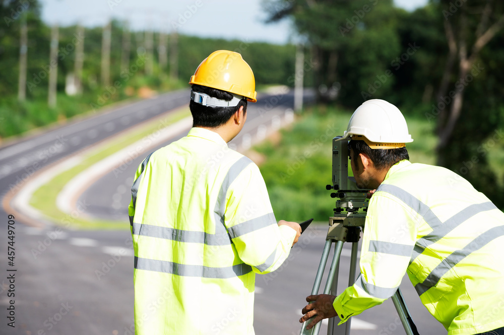 Fotka „Road construction workers use orthogonal surveyors to measure ...