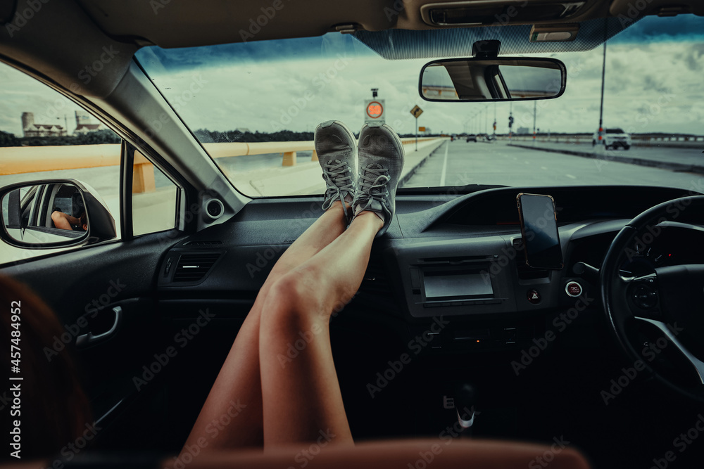 women sitting on passenger seat in car with feet on car dashboard ...