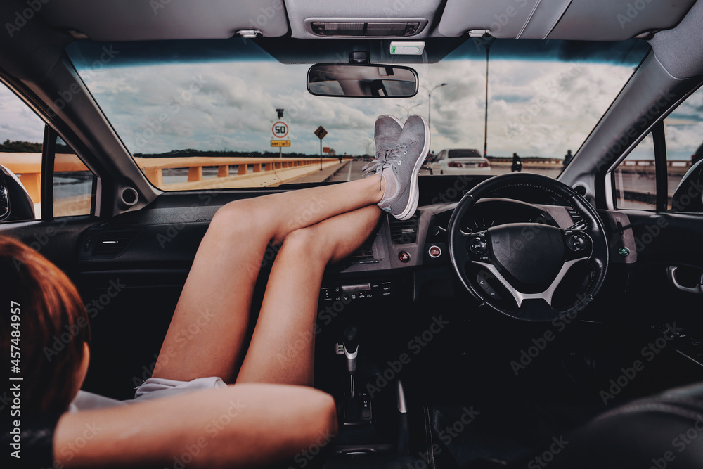 women sitting on passenger seat in car with feet on car dashboard ...