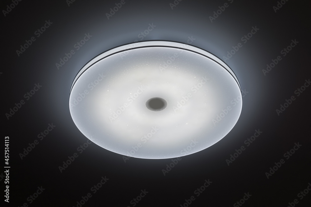 Ceiling round LED illuminator on a dark background. Modern lighting ...