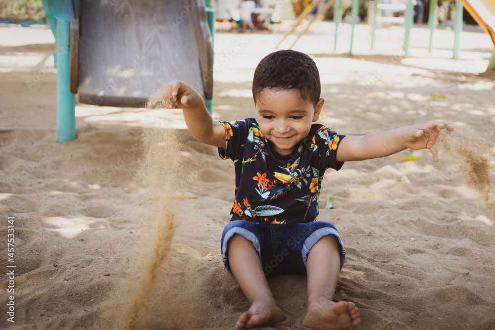 Child playing with sand in the park. Fun in the park. Son playing in ...