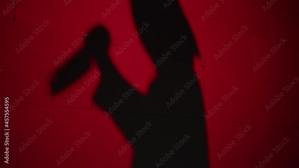 Creepy death silhouette walking with knife on red background. Mystical ...