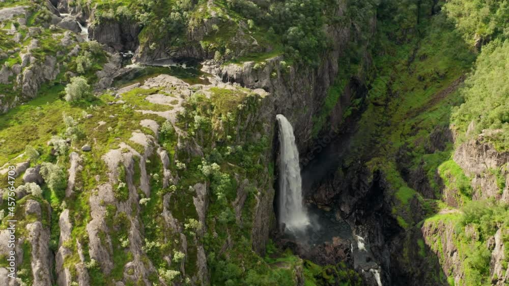 Drone Of Waterfall Cascading Over Cliff Into Lush Valley Stock Video ...