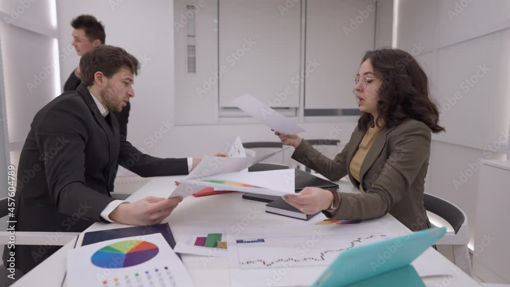 Busy worried male and female managers discussing project as anxious ...