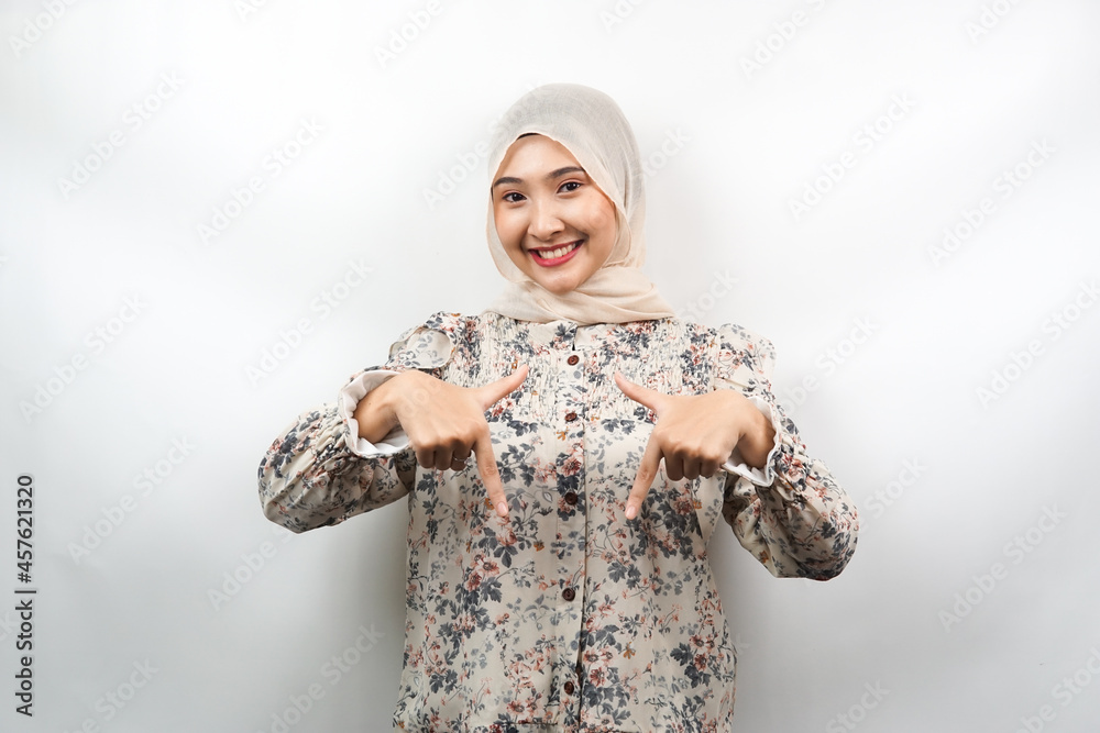 Beautiful asian young muslim woman with hands pointing down, hands ...