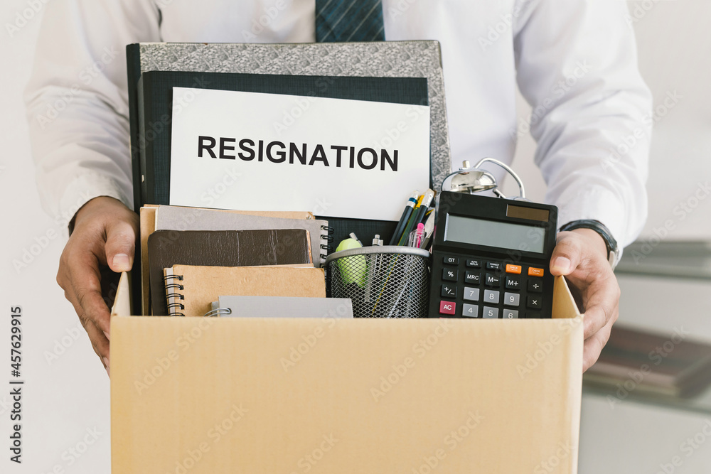 Resignation. businessmen holding boxes for personal belongings and ...