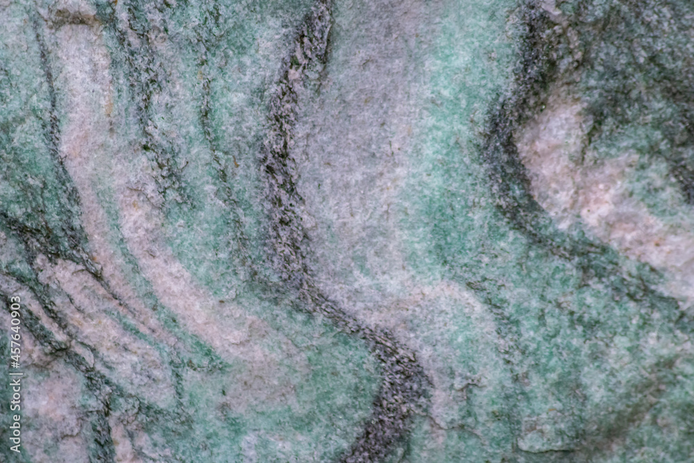 Raw rock in green with minerals and metals as natural stones background ...