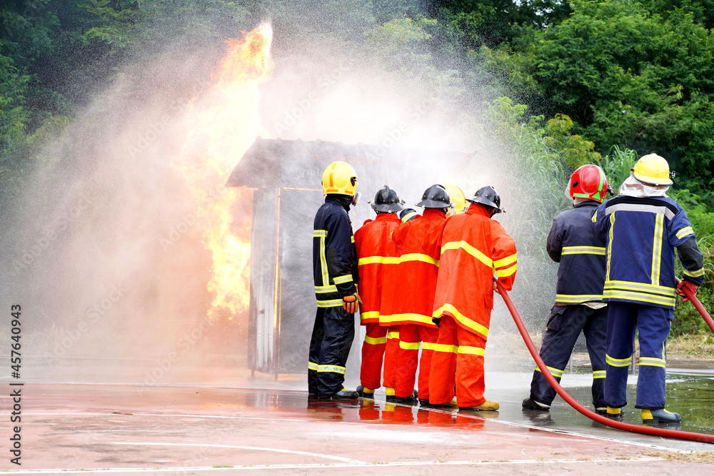 Firefighters using Twirl water fog type fire extinguisher to fighting ...