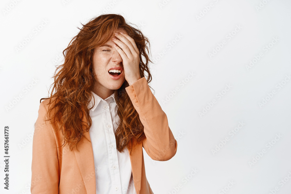 Upset redhead woman facepalm, standing distressed and tired in office ...