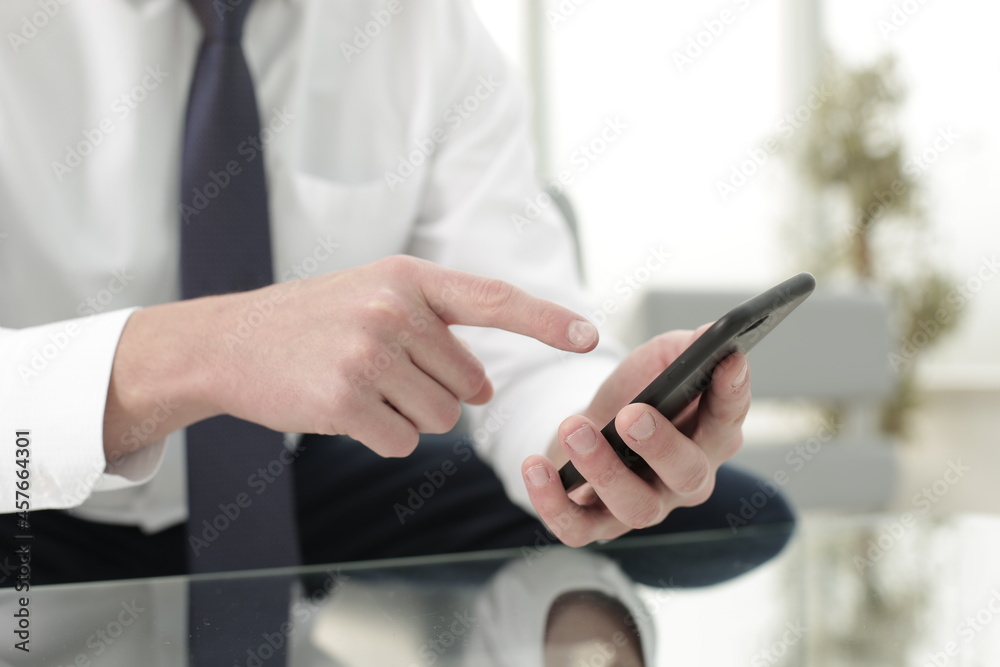 The company manager holds the phone in one hand and points to the phone ...