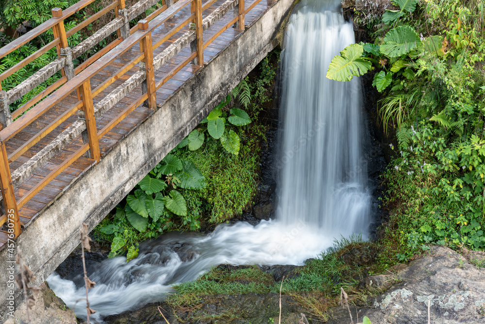 The water in the river forms a small waterfall Stock Photo | Adobe Stock