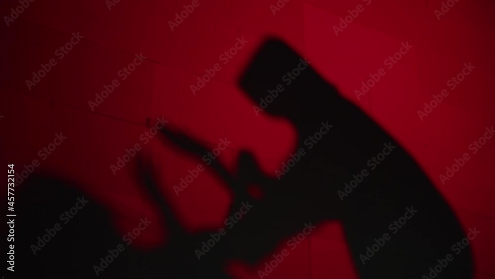 Creepy death silhouette killing victim with knife on red background ...