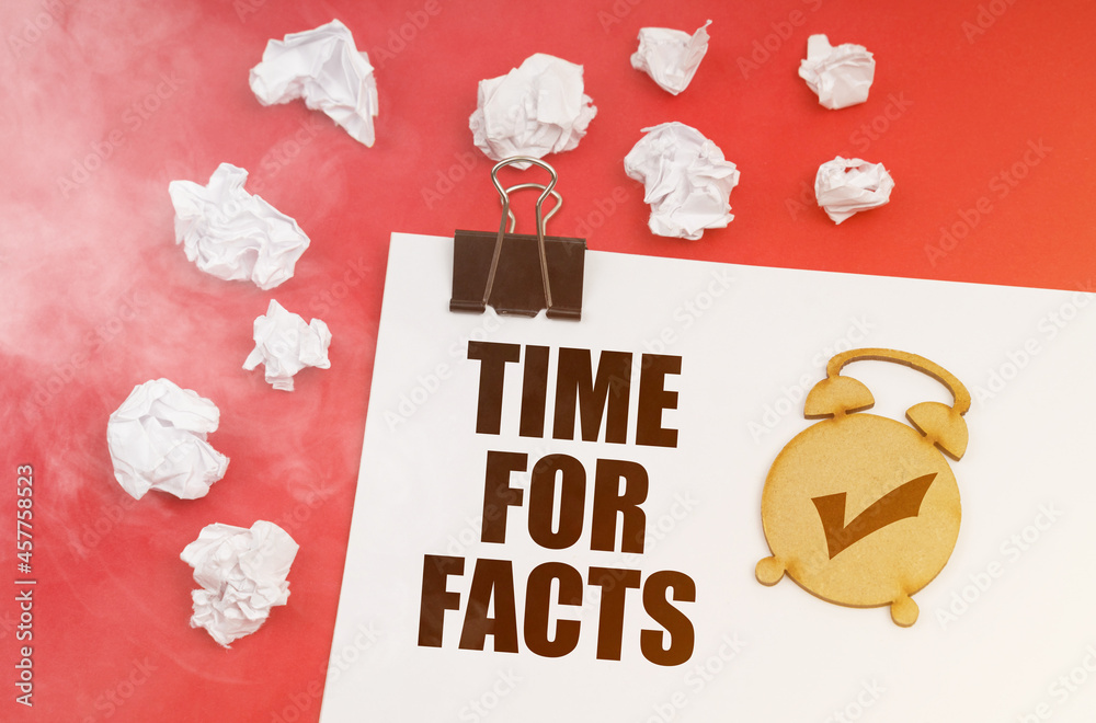 On a red background in smoke, crumpled paper and a sheet with the ...