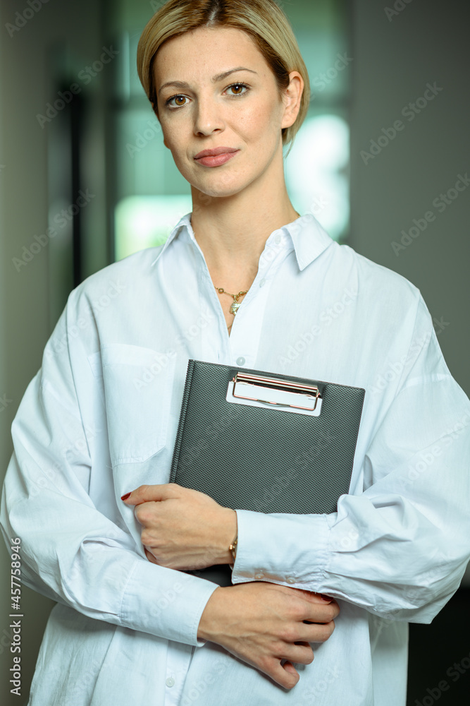 Medical worker portrait. Nurse holding files. Short hair blonde female ...