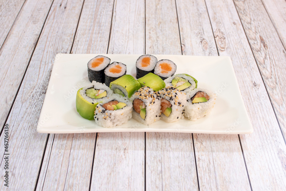Sushi maki roll and uramaki california roll with Norwegian salmon ...