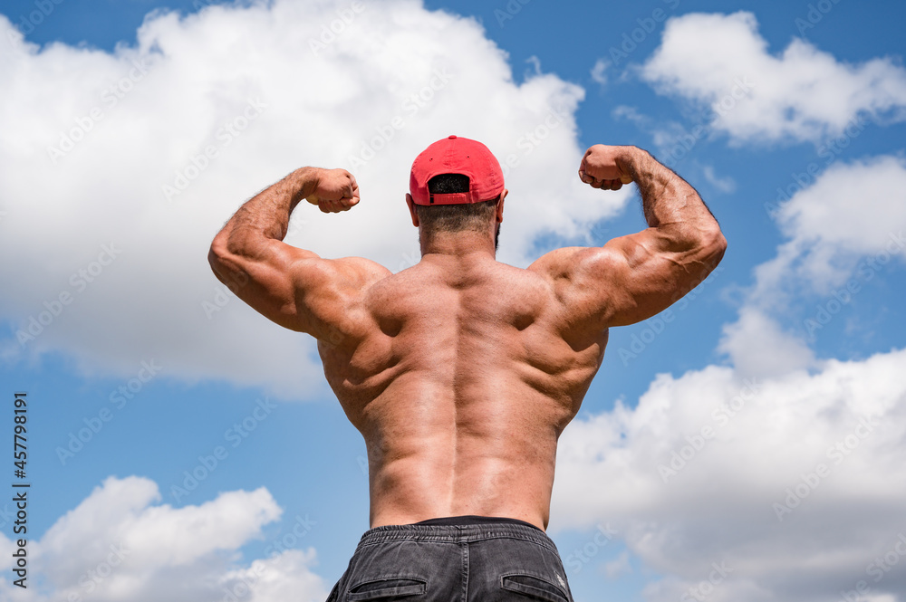 strong young athlete fitness bodybuilder male in red cap showing his ...