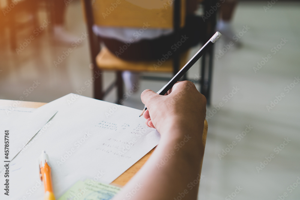 Asian Students hands holding pencil doing multiple-choice quizzes or ...
