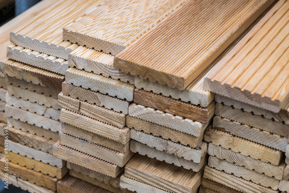The larch decking is made of solid wood in a stack. The texture of boards for the arrangement of ...