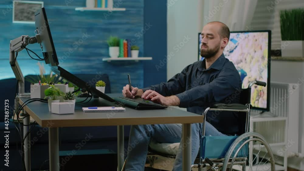 Disabled photographer editing pictures in photography studio. Man with ...