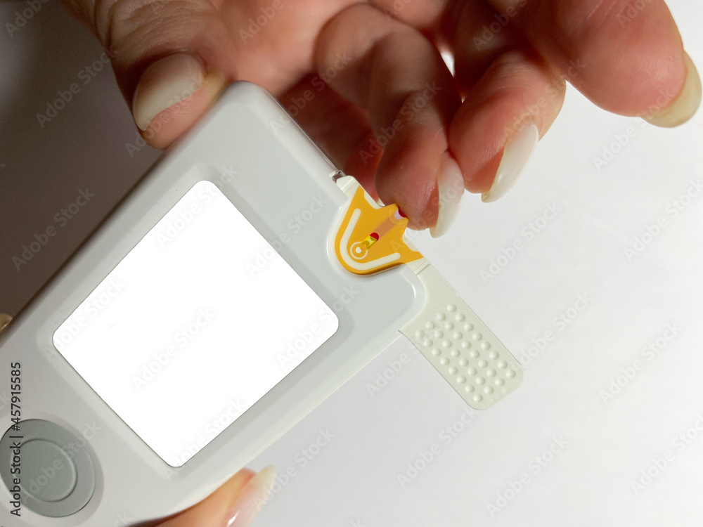 Measurement of blood sugar levels using a glucose meter with a mock-up ...