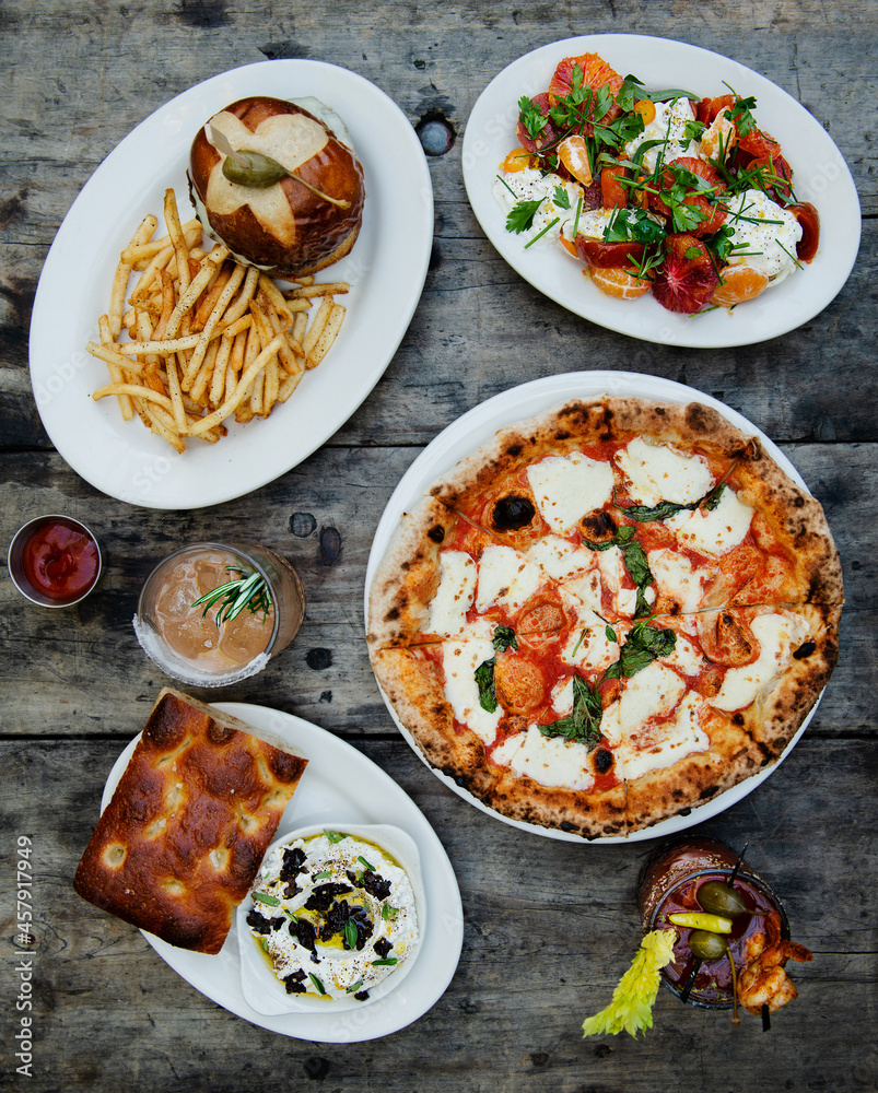 Italian food spread with Margherita pizza, salad, burger Focaccia and ...