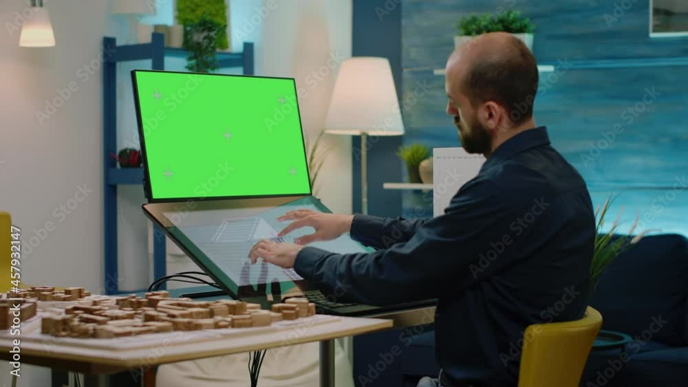 Architect using horizontal green screen and building model working on ...