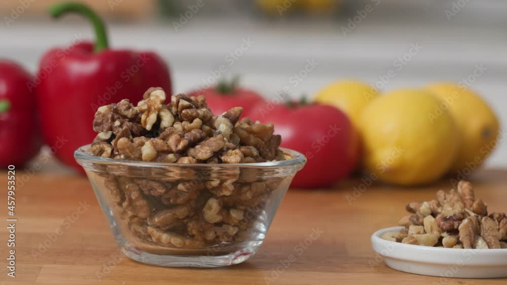 Slide right shot 4k of two portions of italian nuts (fats). One portion ...