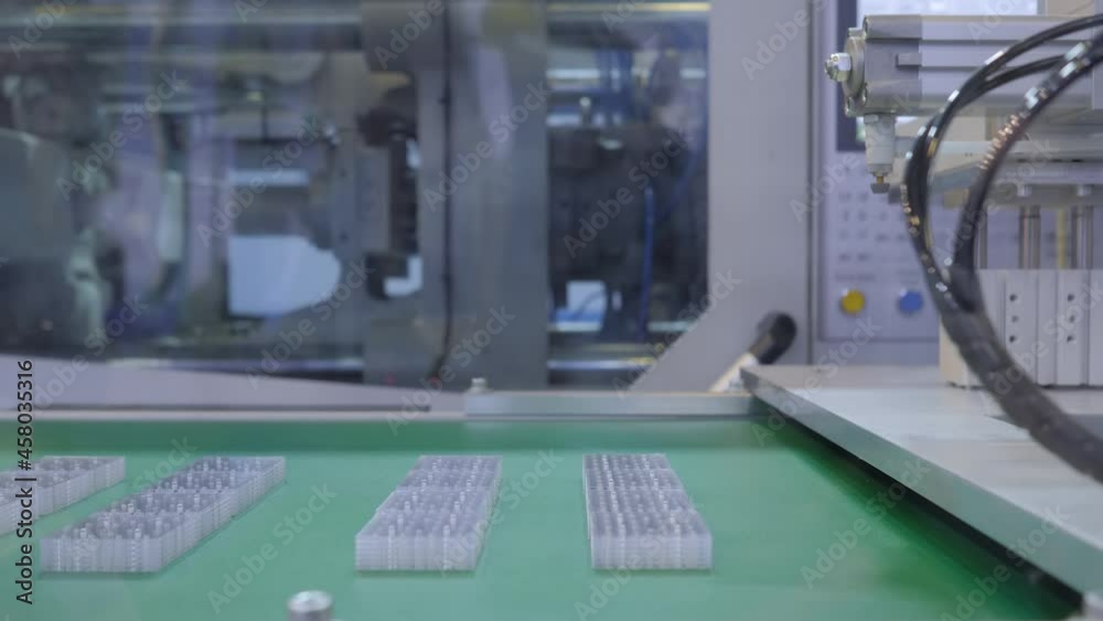 Pick and place yellow robotic arm manipulator moving flat plastic ...