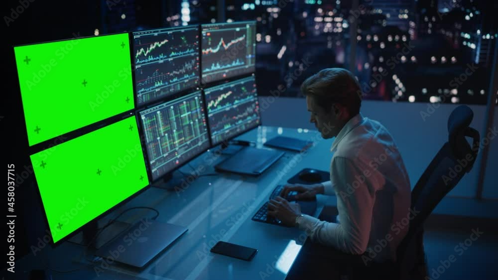 Financial Analyst Working on Computer with Multi-Monitor Workstation ...