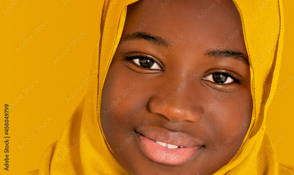 Muslim girl smiling, yellow background Stock Photo | Adobe Stock