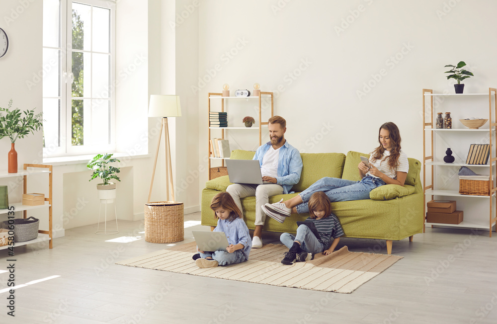 Family sitting in cozy spacious Scandinavian livingroom with wireless ...