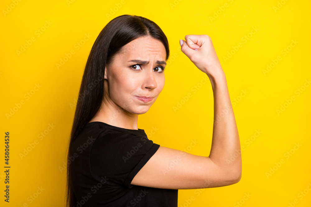 Profile portrait of young person hand showing flex biceps look camera ...