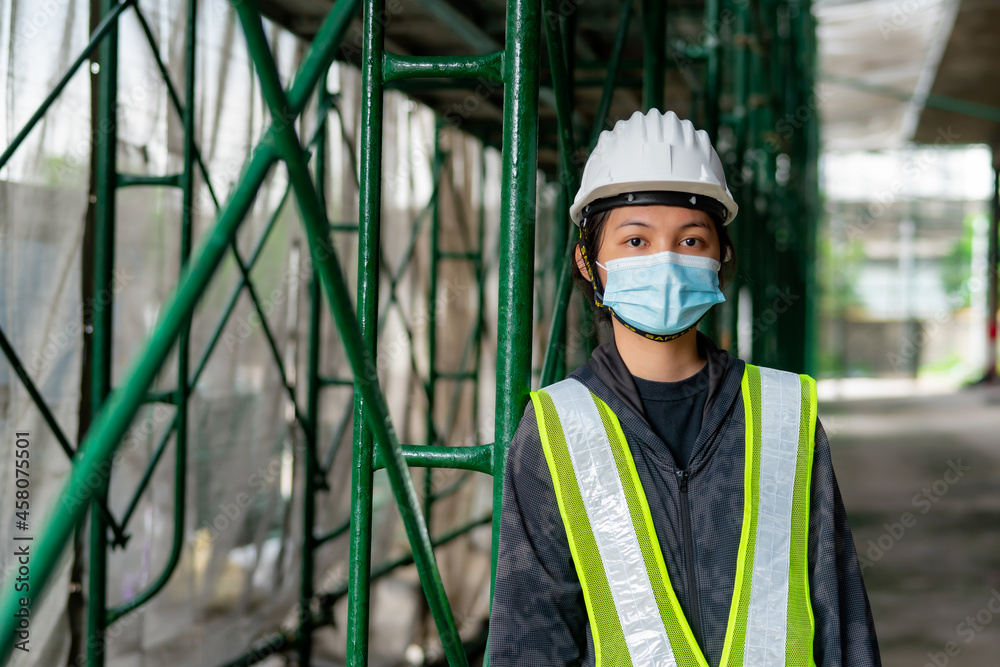 Young Asian female engineer wearing a medical mask to cover her mouth ...