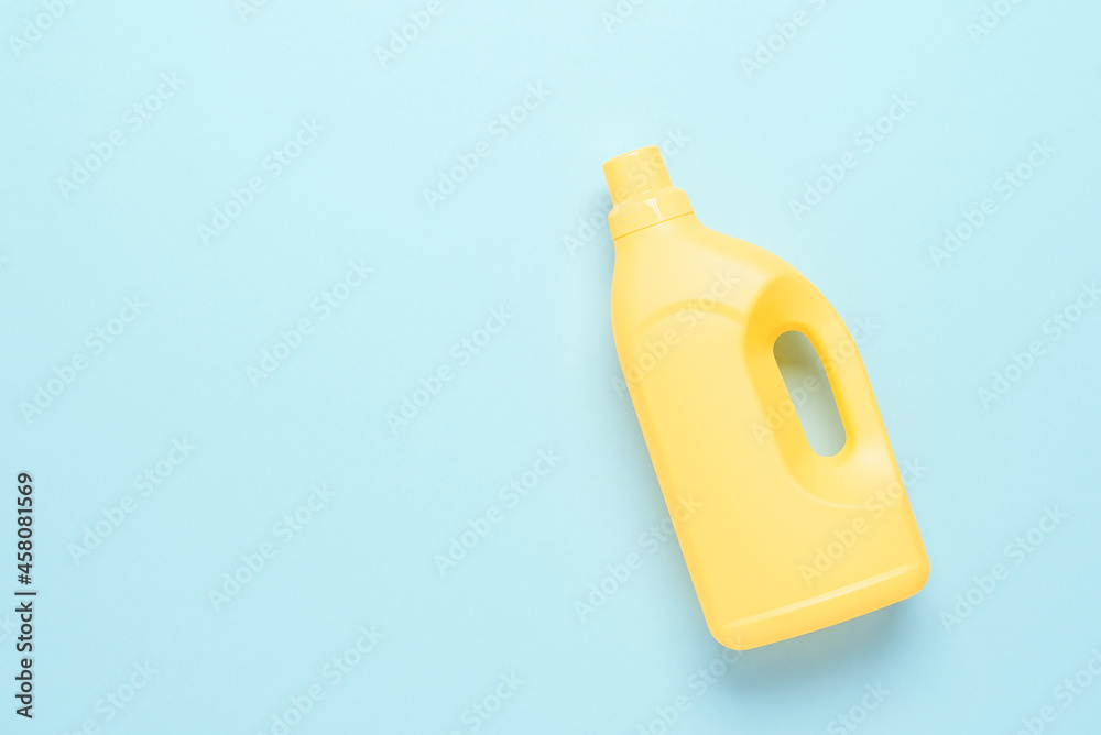 Yellow plastic packaging bottle on a light blue pastel background. Top ...
