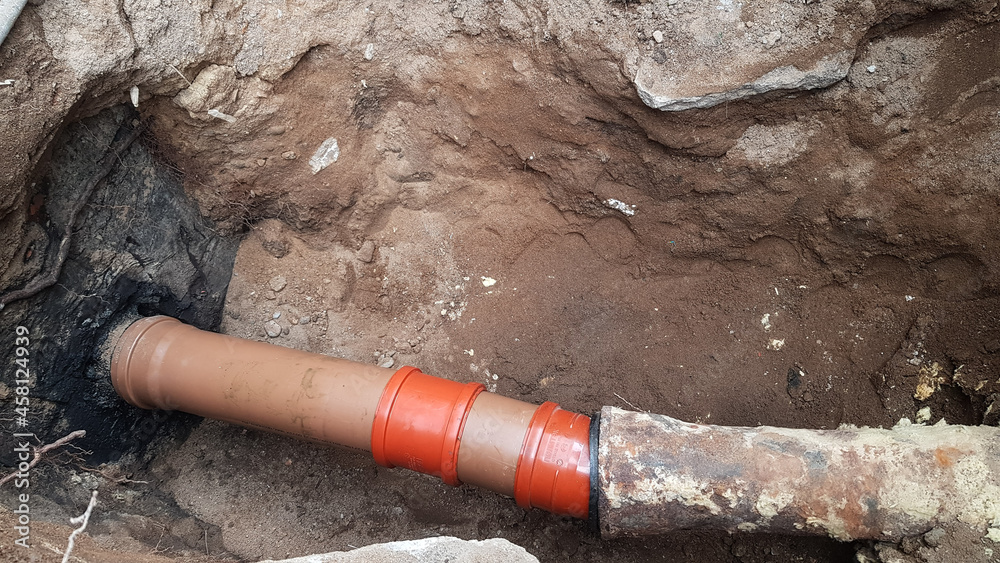 the sewer pipe burst. a dug hole for the repair of sewer pipes. care and maintenance in a ...
