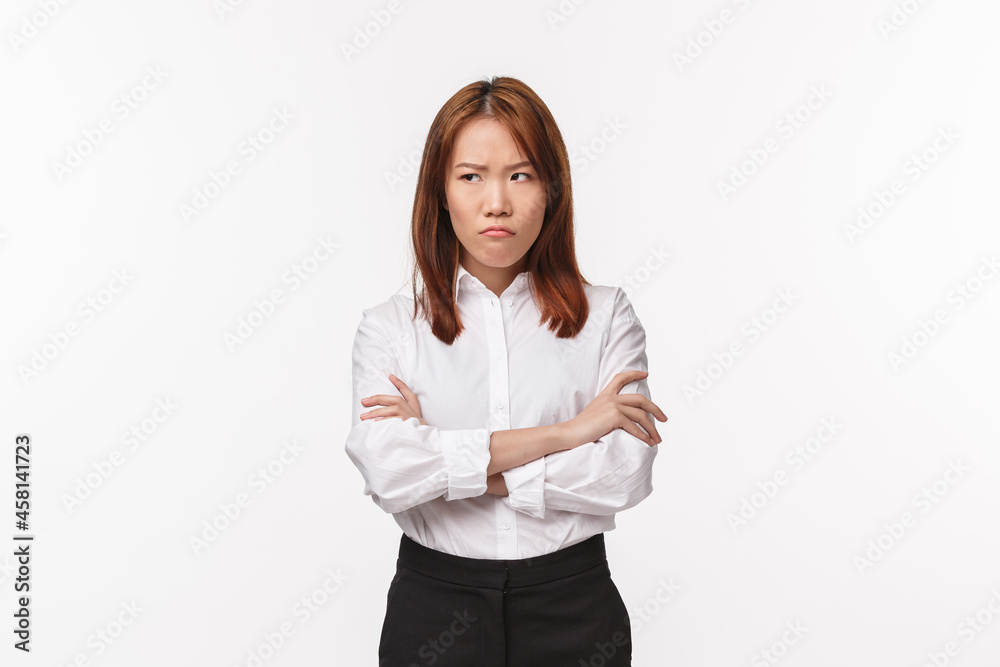 Portrait of grumpy and offended young asian woman, cross hands on chest ...