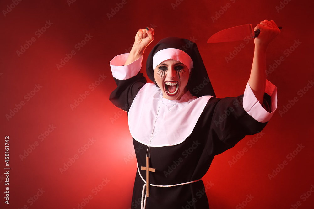 Woman dressed for Halloween as nun with knife on color background Stock ...
