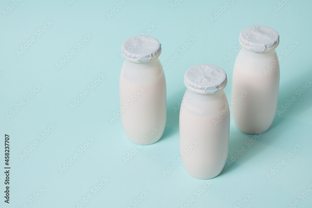 Bottles with probiotics and prebiotics dairy drink on light blue ...