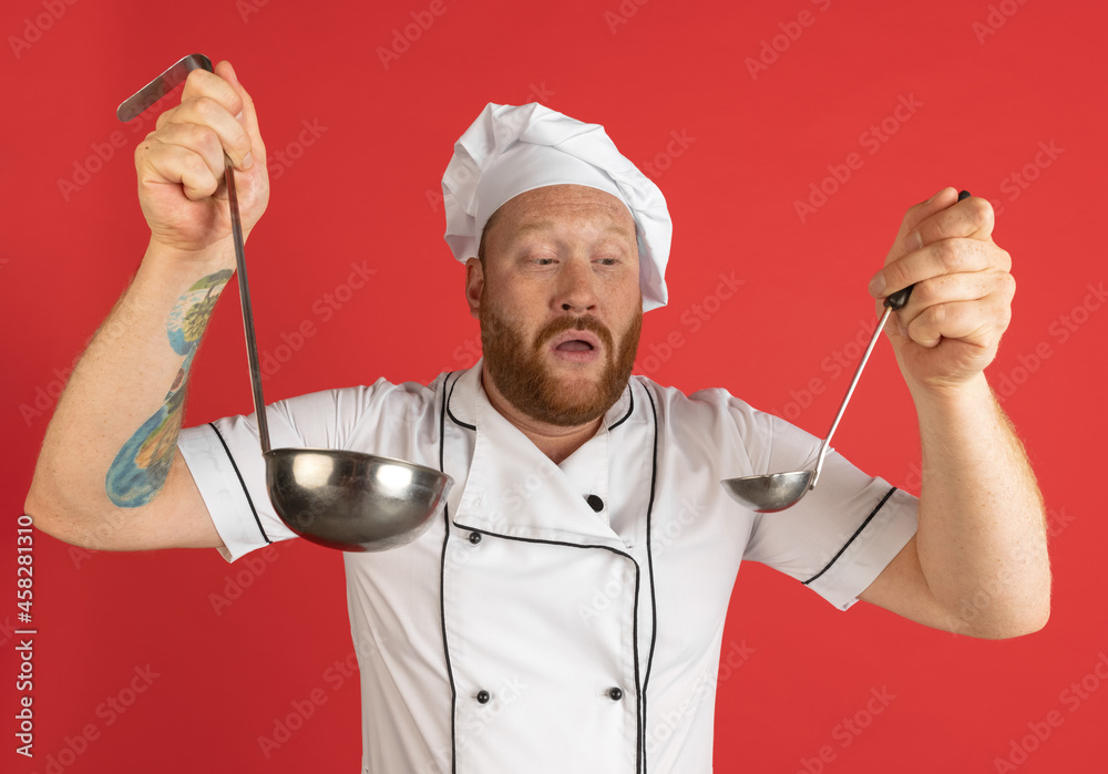 Comic portrait of hadsome bearded man, cook, male chef in white uniform ...