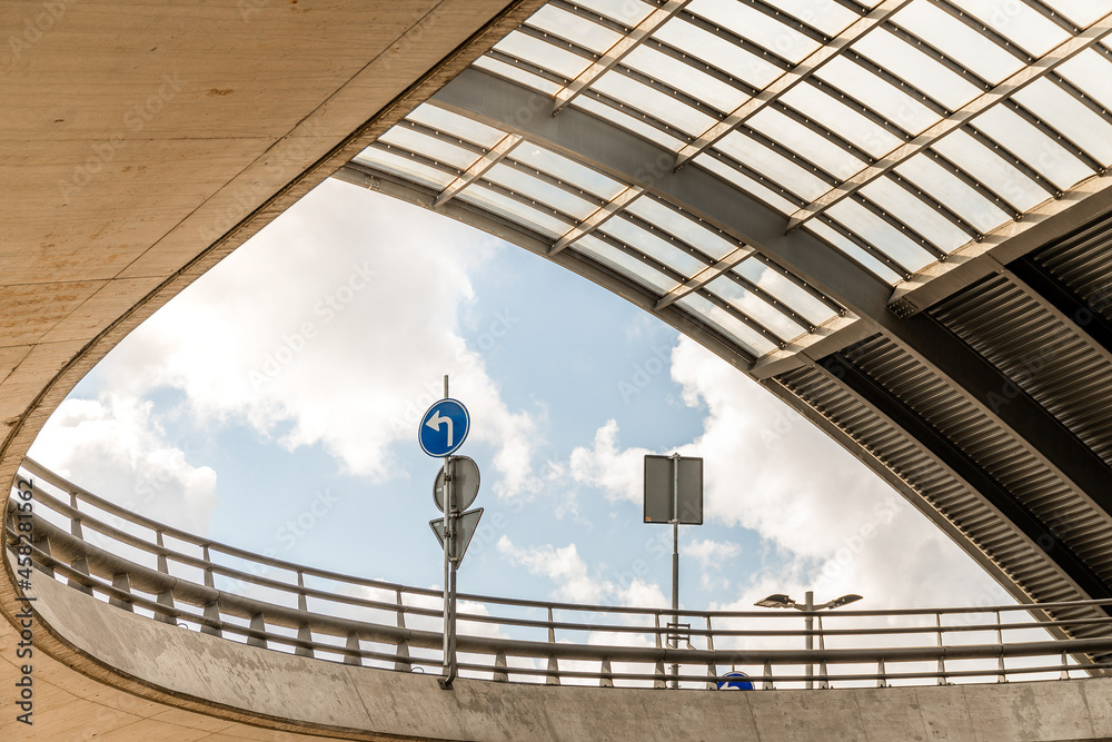 Road signs on roadway under arch Stock Photo | Adobe Stock