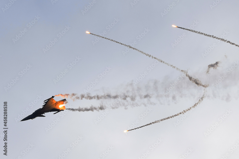 JAS-39 Gripen Fighter Jet with somke and flares. Stock Photo | Adobe Stock