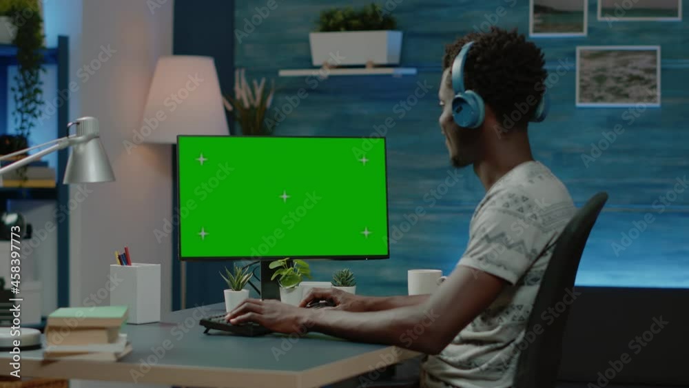 Entrepreneur working on computer with horizontal green screen. Man ...