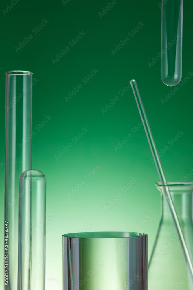 Laboratory glass equipment on radiant green background. Research and ...