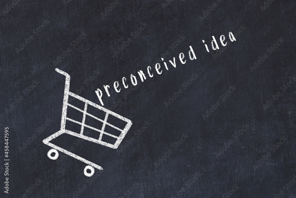 Chalk drawing of shopping cart and word preconceived idea on black ...